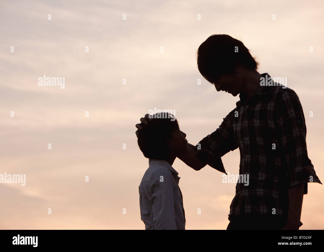 Father stroking sons head Stock Photo - Alamy
