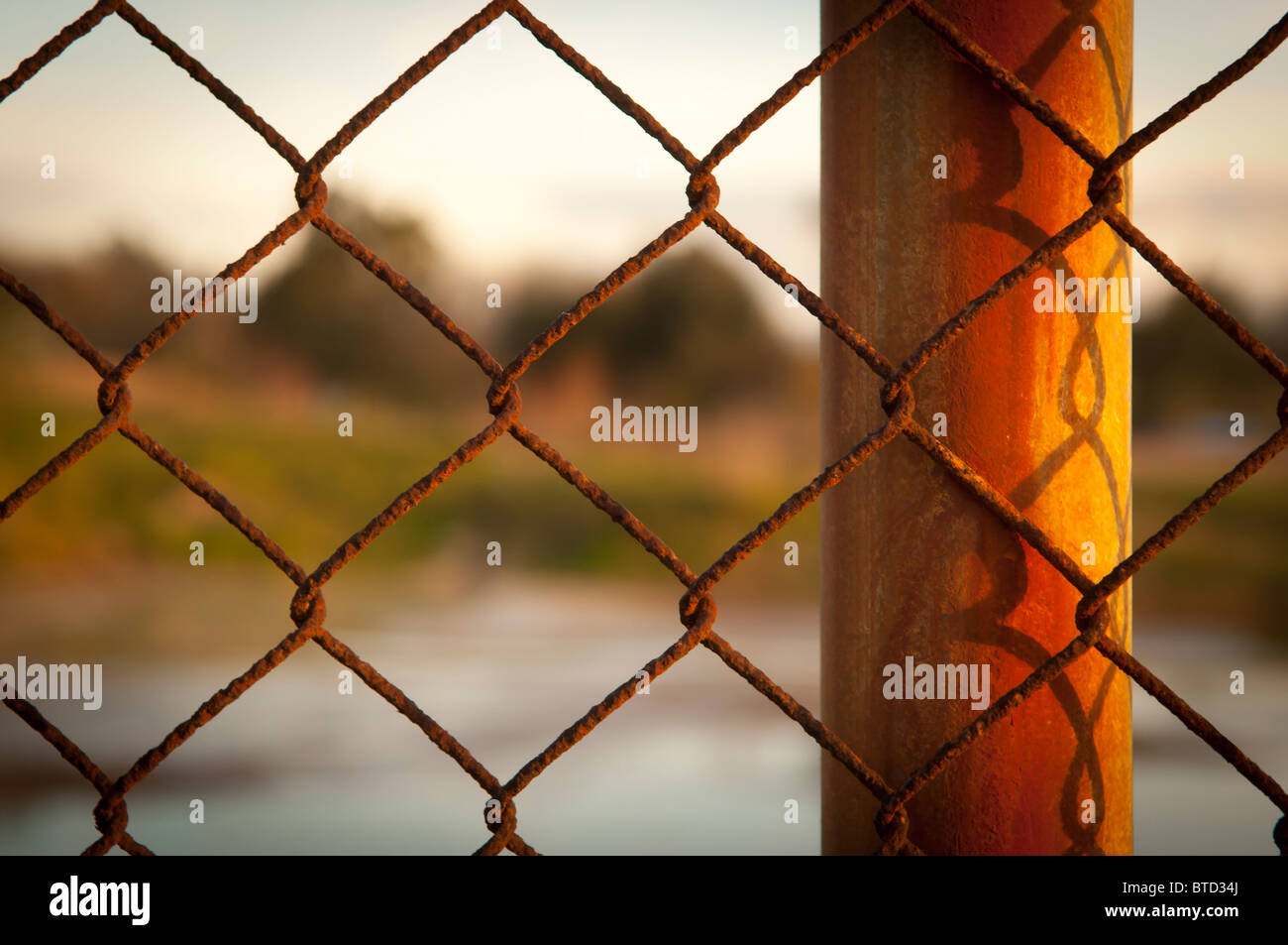 Rusty wire fence (cyclone fencing) in repeating patterns Stock Photo ...