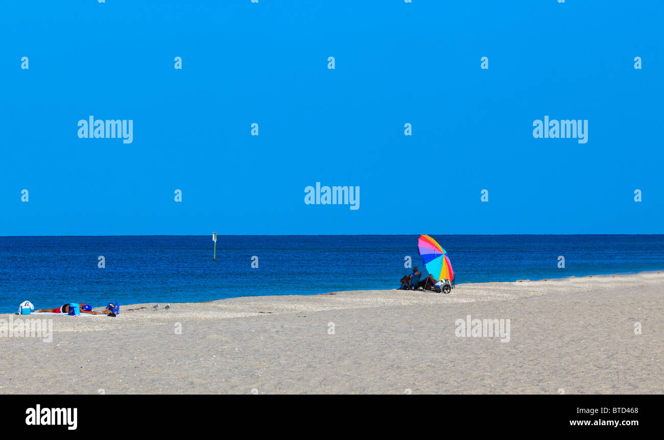 Under a beach umbrella Stock Photo - Alamy