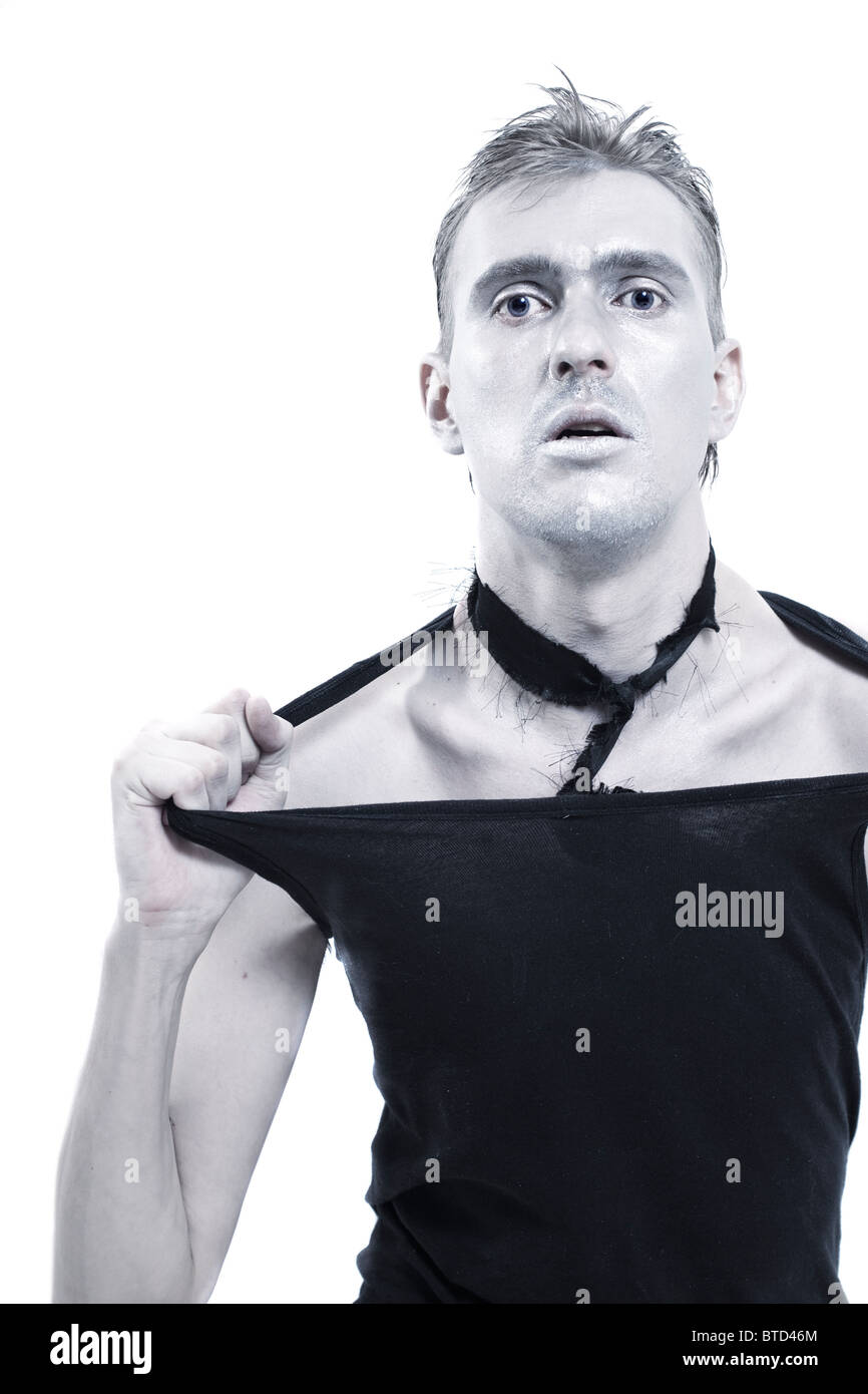 Portrait of Young man tearing at his shirt Stock Photo - Alamy