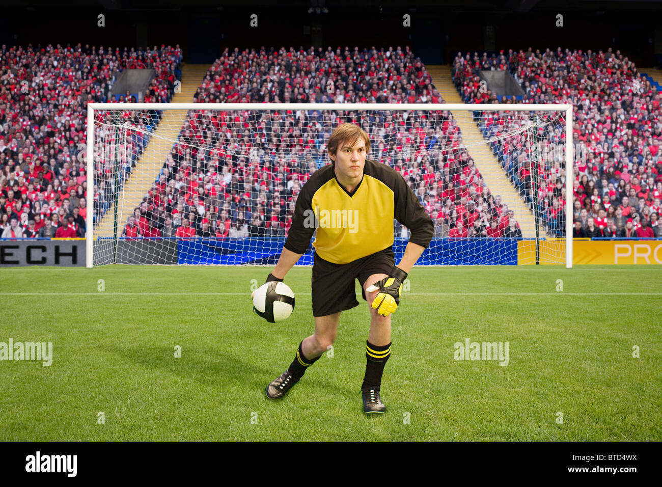 Goalkeeper throwing football Stock Photo - Alamy