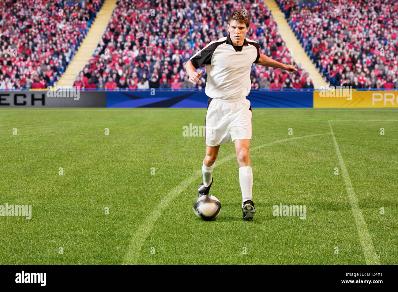 Football player kicking the ball Stock Photo - Alamy