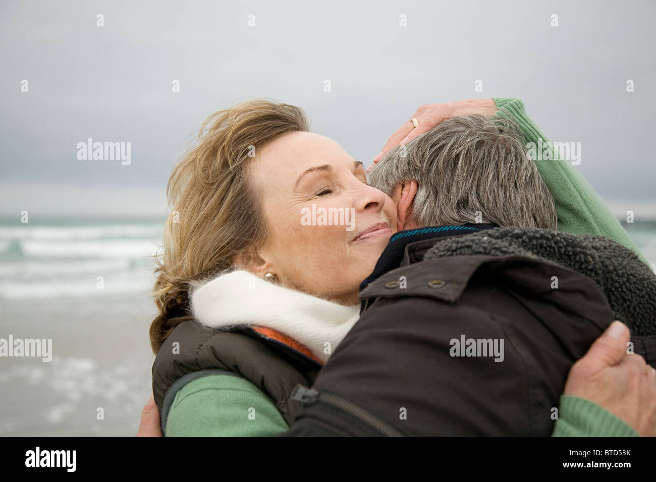 Mature couple hugging at the coast Stock Photo - Alamy