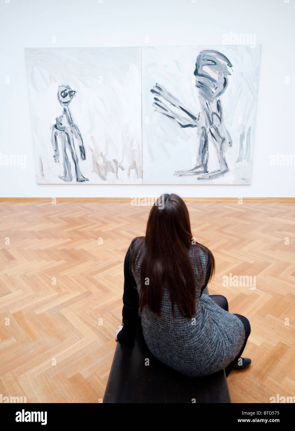 Woman looking at painting Encounter with God by Karel Appel at the ...