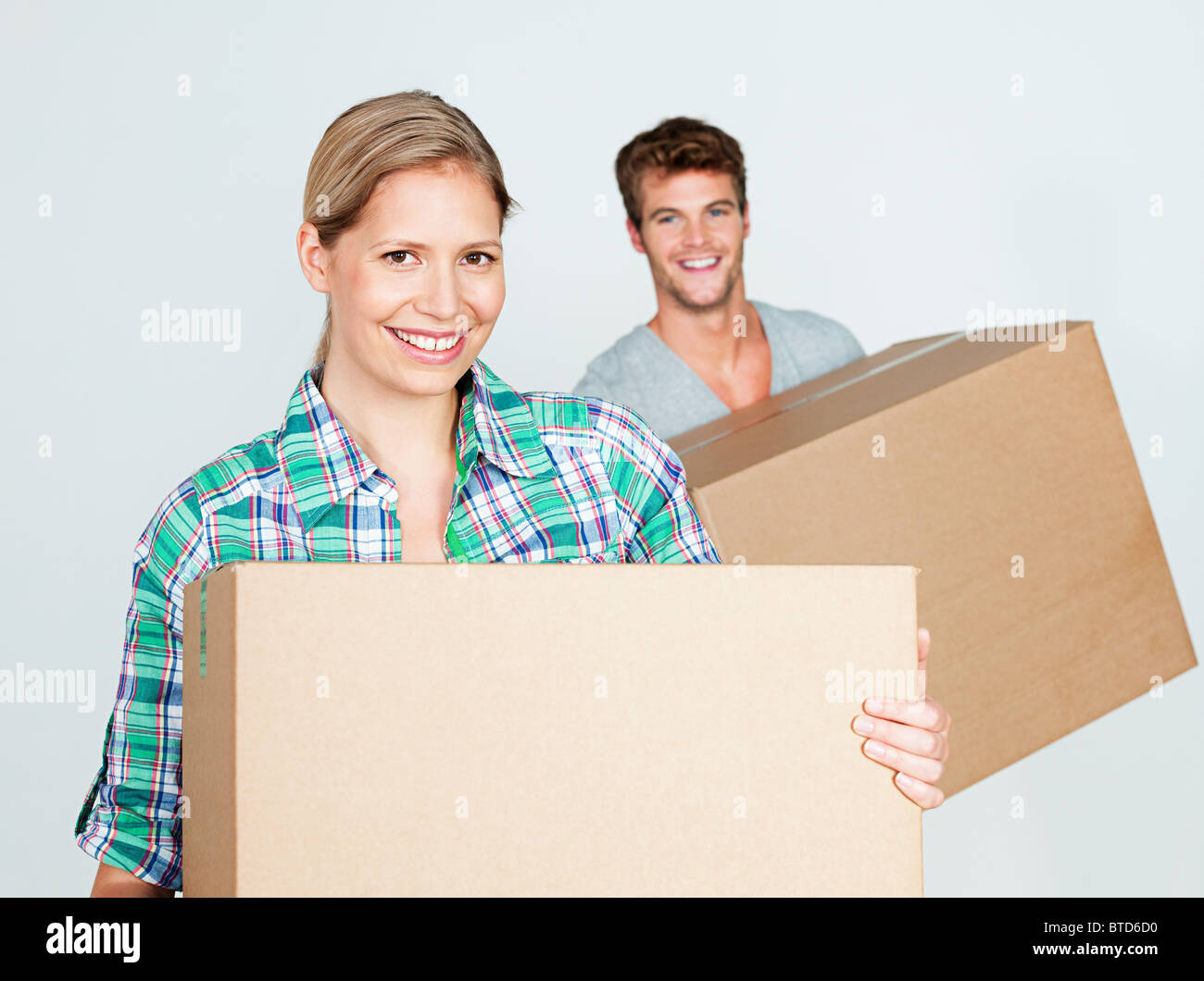 Young couple with cardboard boxes Stock Photo - Alamy