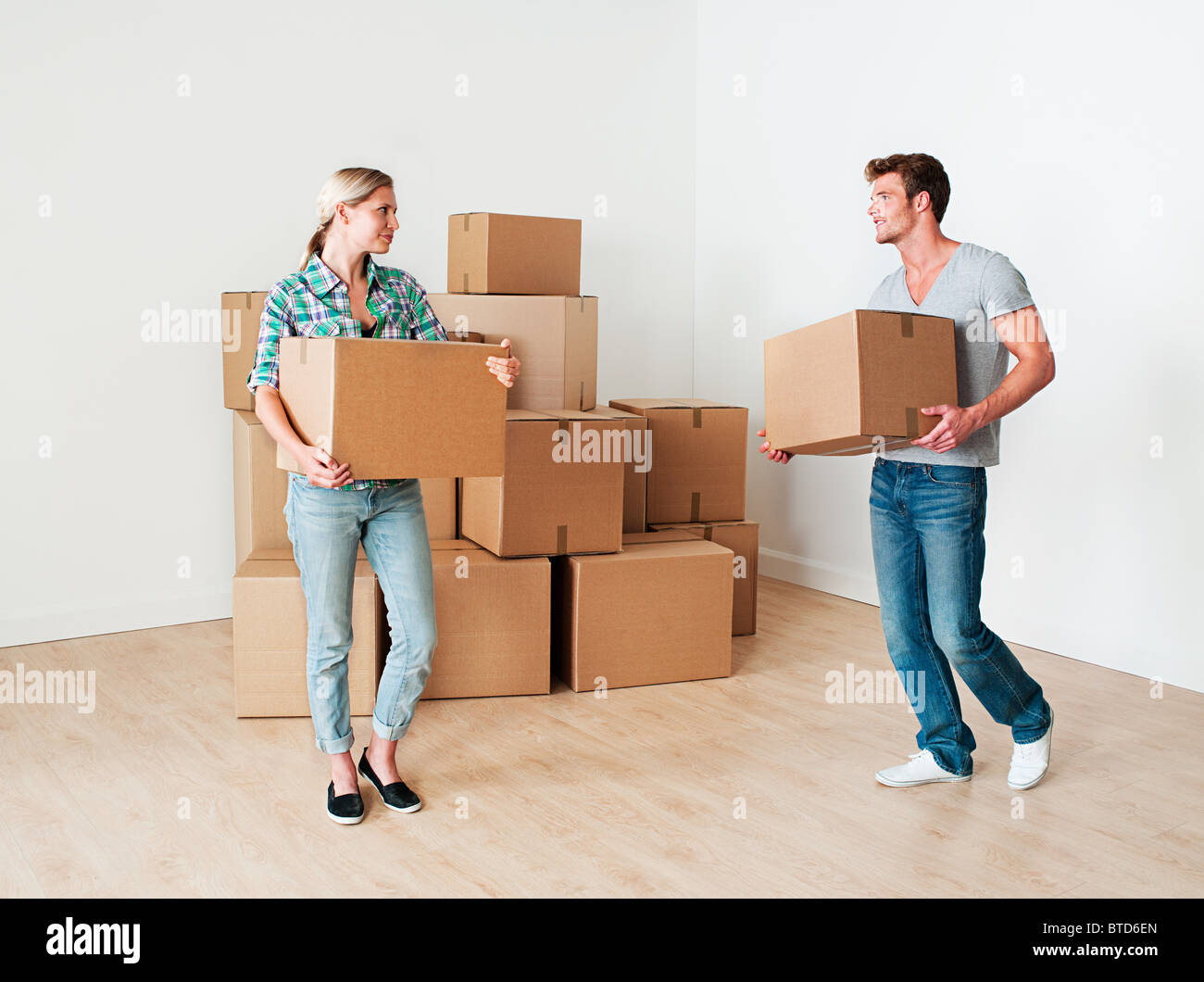 Young couple moving boxes Stock Photo - Alamy