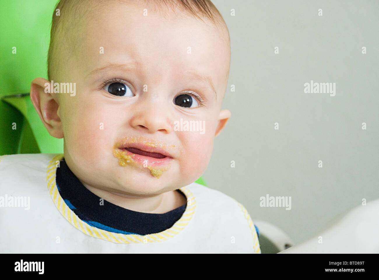 Baby with food round his mouth Stock Photo - Alamy