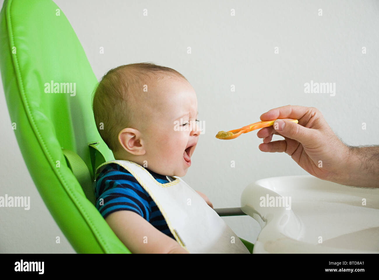 Baby being fed Stock Photo - Alamy