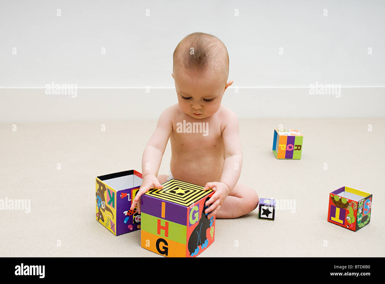 Baby playing with toy blocks Stock Photo - Alamy