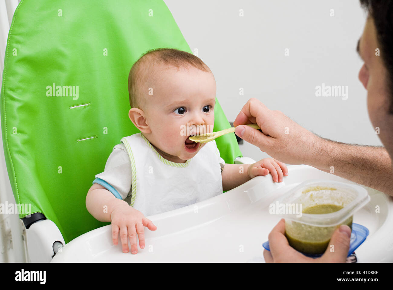 Baby being fed Stock Photo - Alamy