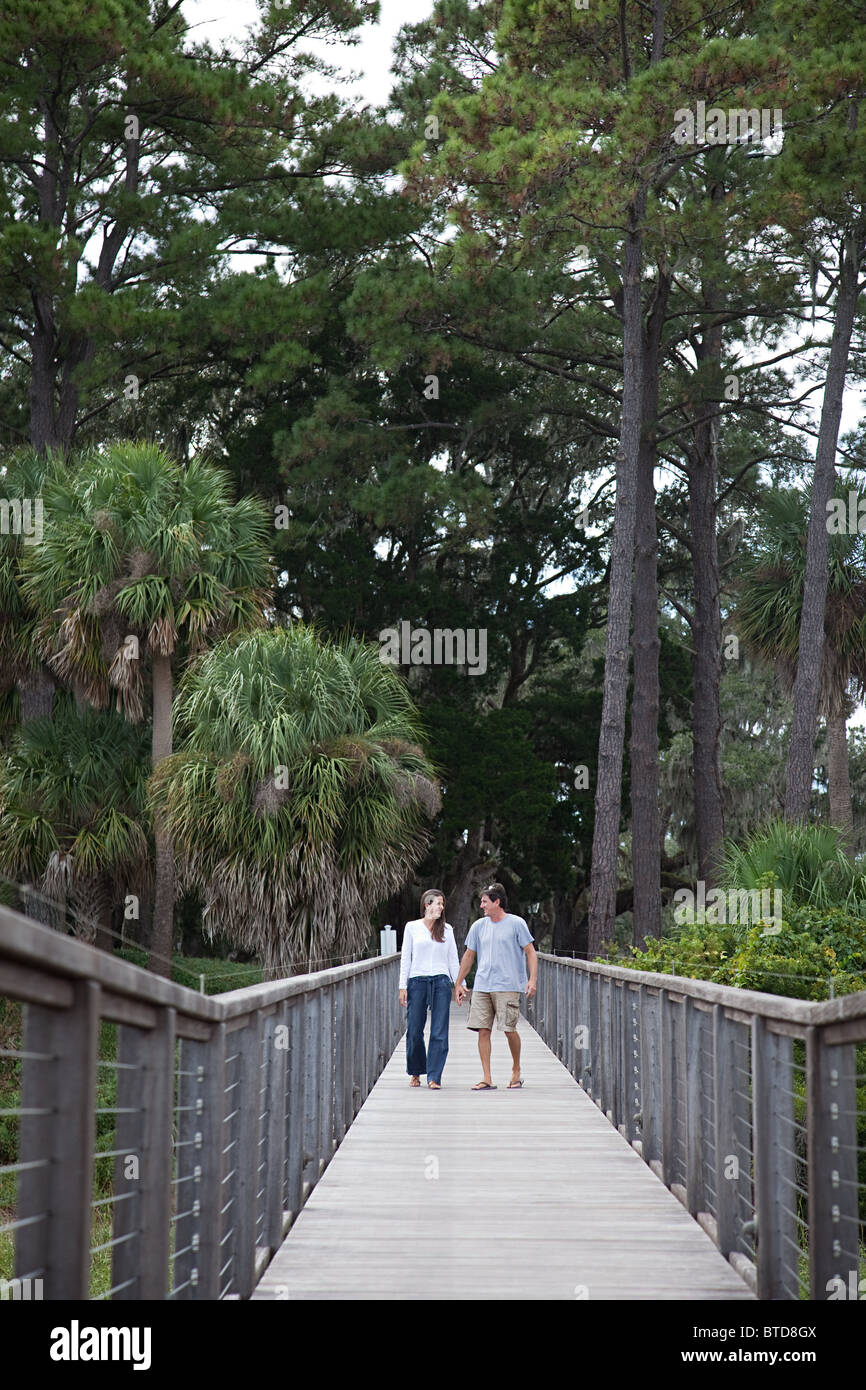 Couple walking over walkway Stock Photo - Alamy