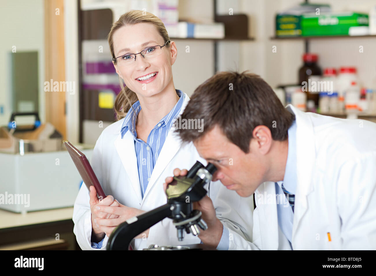 Doctors with microscope Stock Photo - Alamy