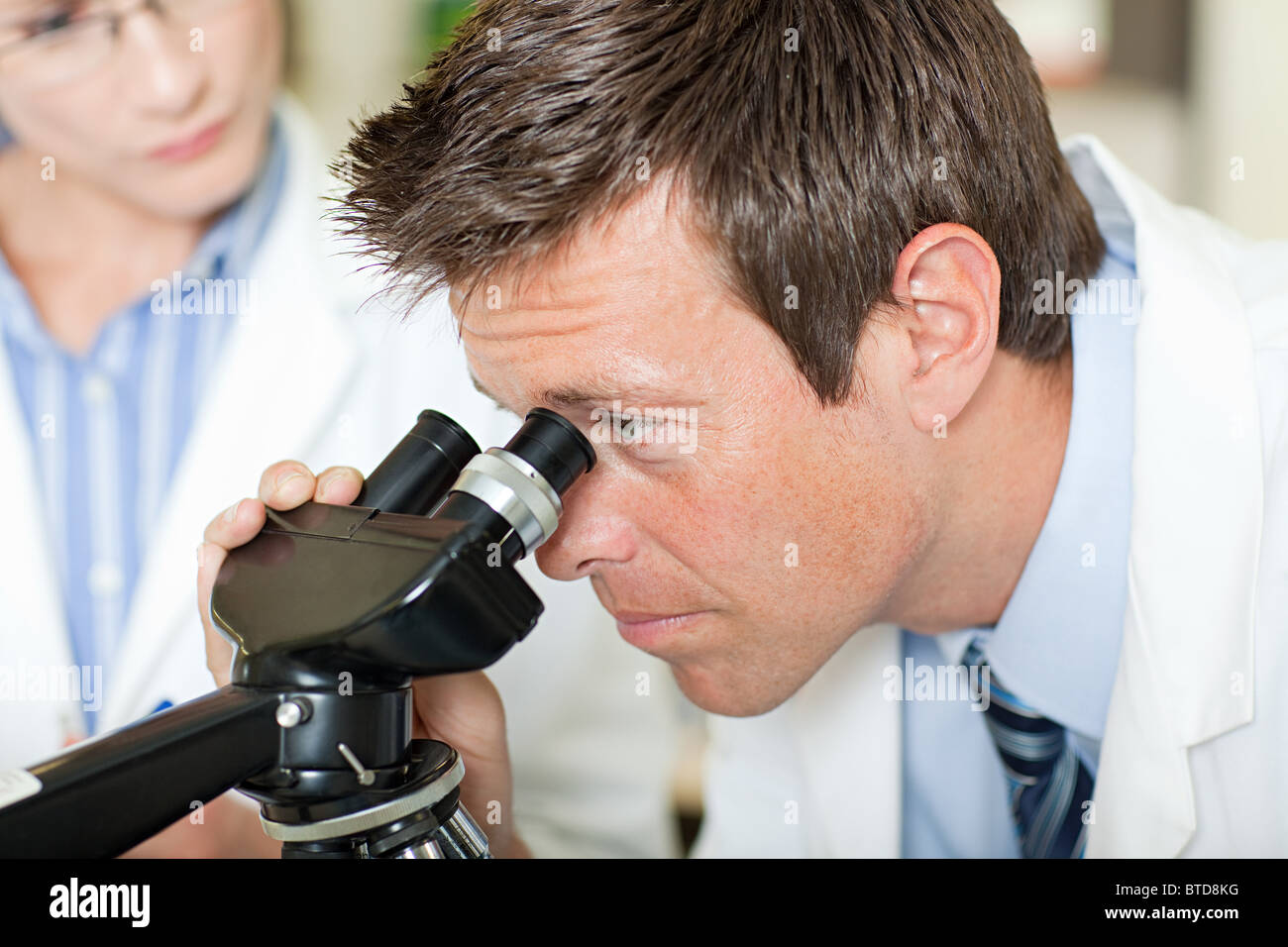 Doctors with microscope Stock Photo - Alamy