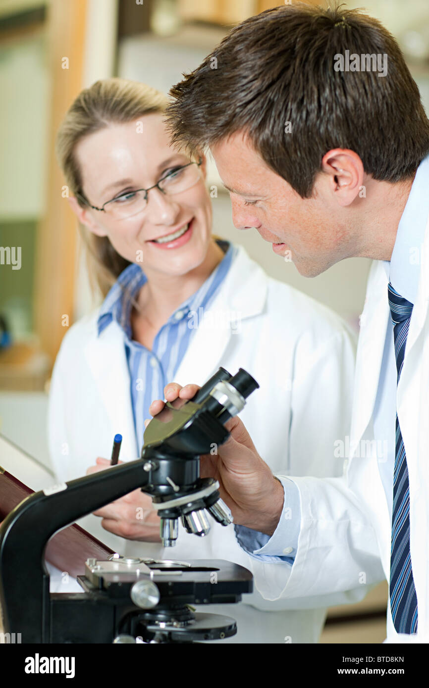Doctors with microscope Stock Photo - Alamy