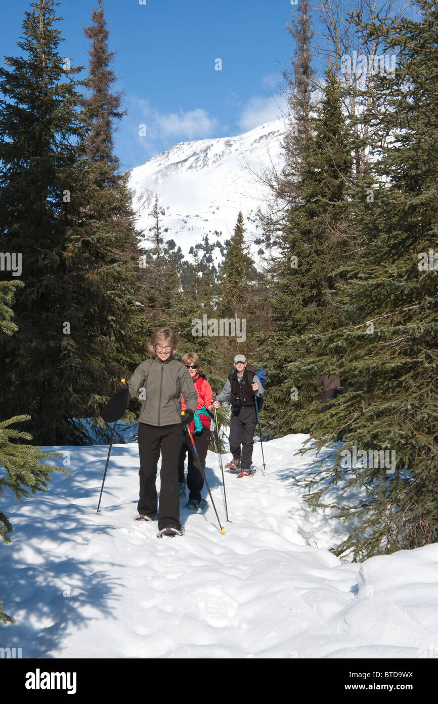 Group of friends snowshoe in the Chugach National Forest near Turnagain ...