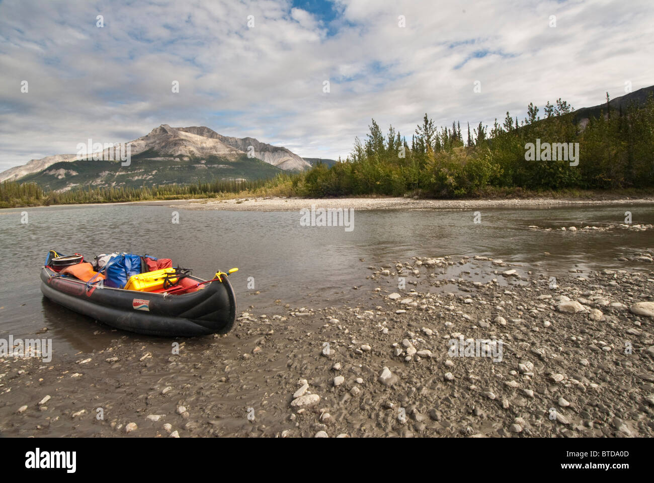 An inflatable canoe rests on the shore of the Alatna River in Gates of ...