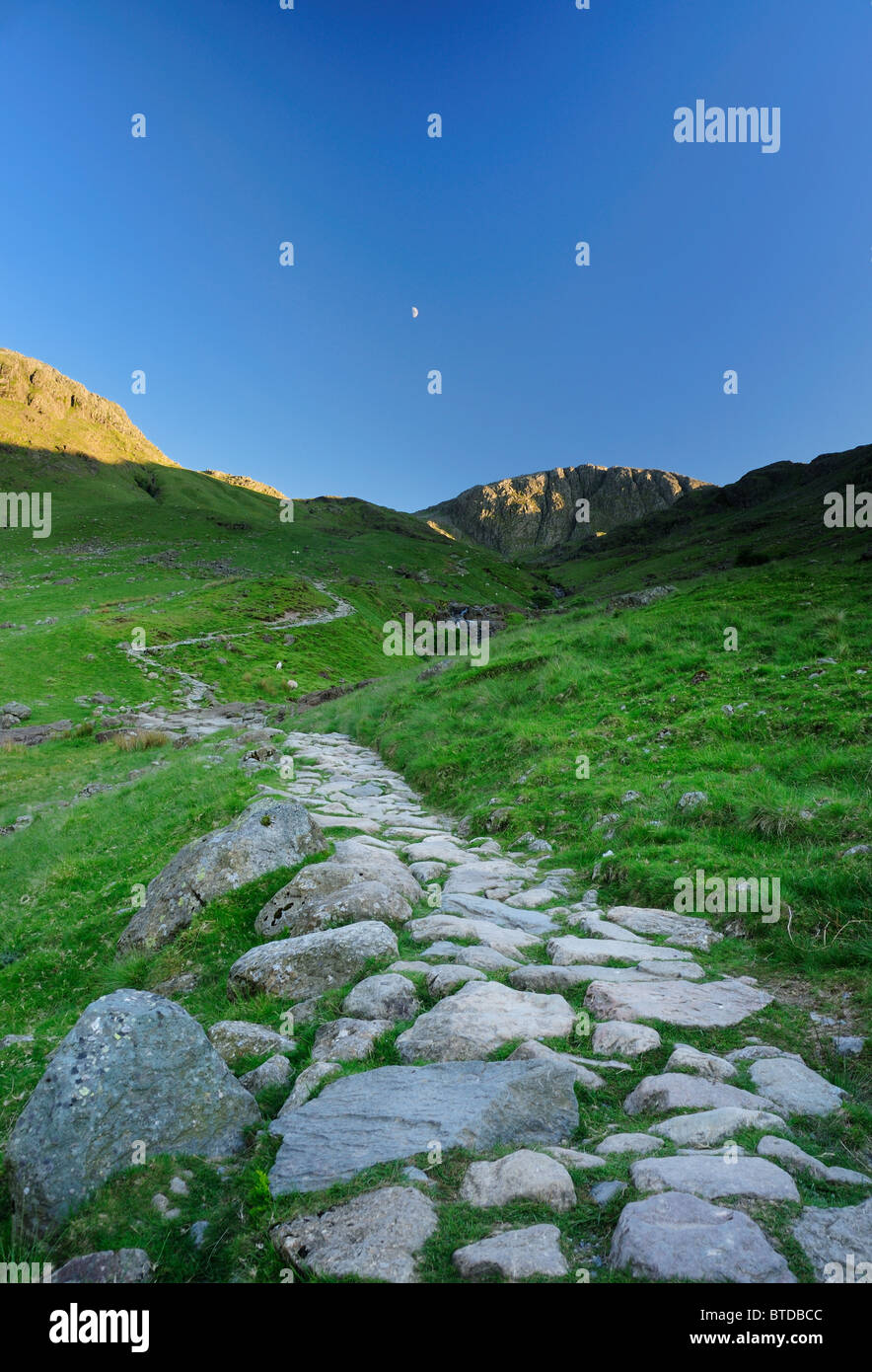 Mountain footpath and late evening sunlight on Great End in the English ...