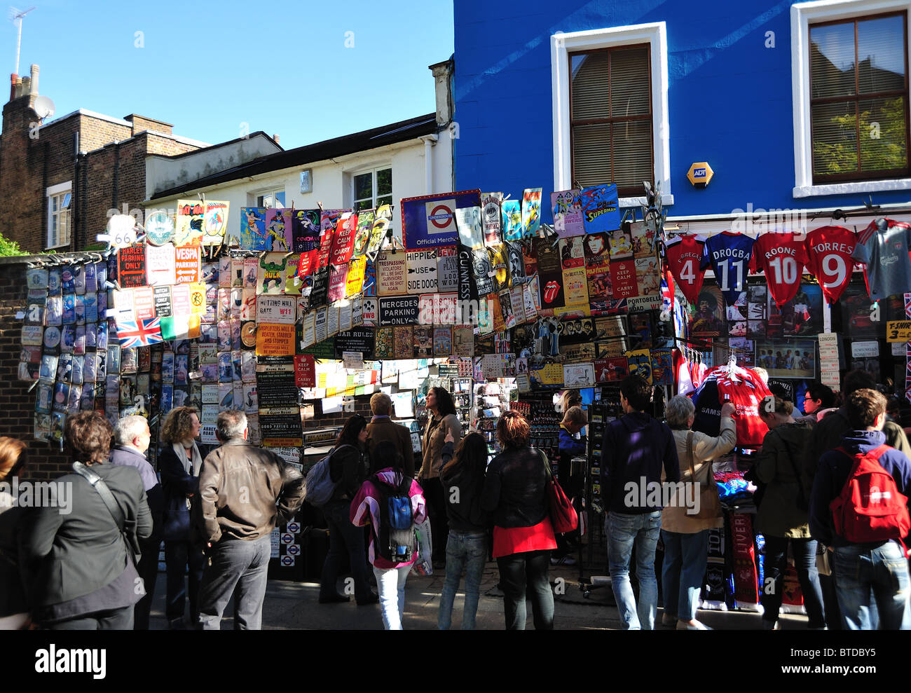 People at a store selling signs, plates in Portobello Market, Notting ...