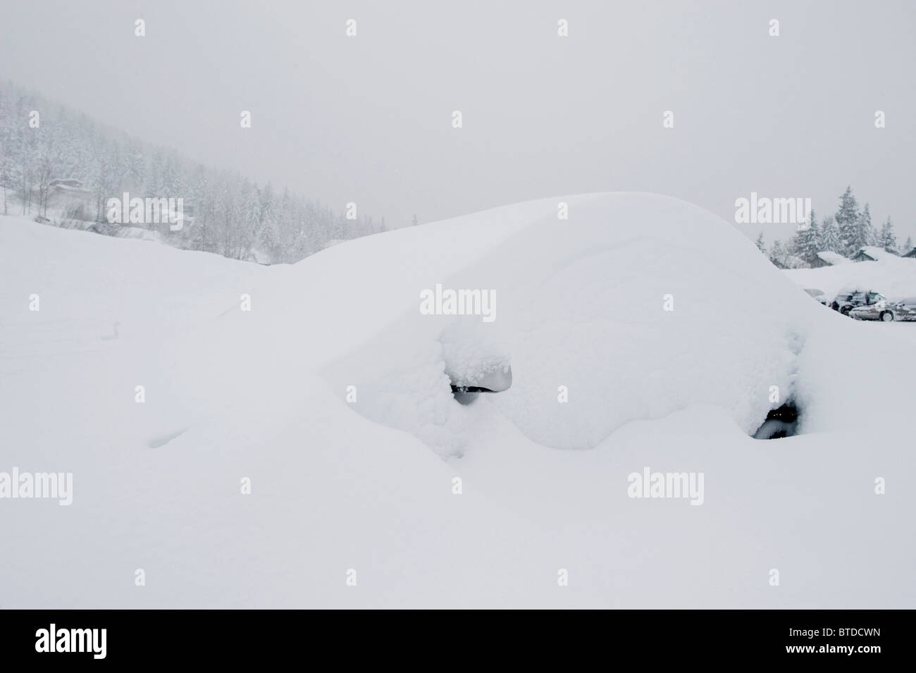 A small car is buried in deep snow at the base of Alyeska Ski Resort ...
