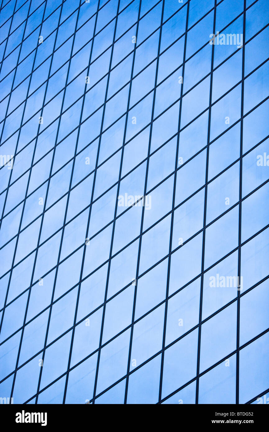 Clouds and sky reflected in windows of an office high rise in downtown ...