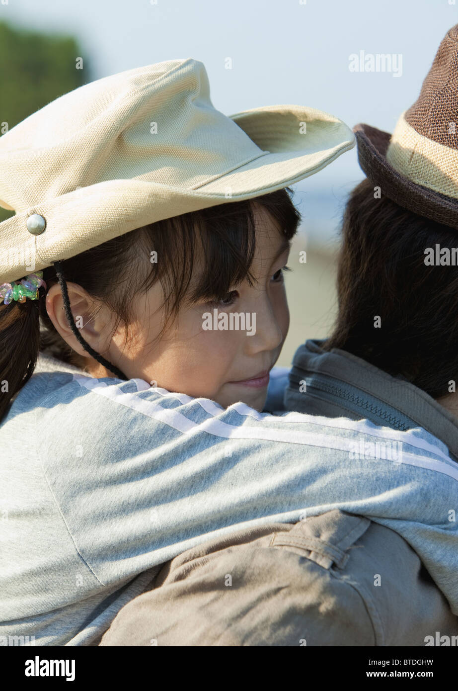 Girl being given piggyback by father Stock Photo - Alamy