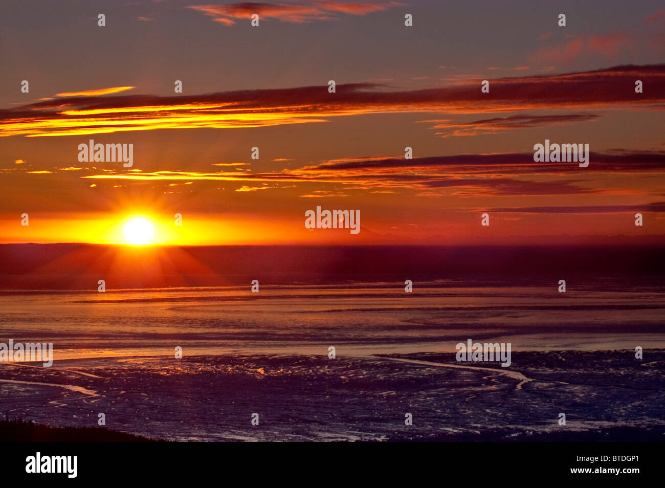 Scenic view of sunset over Cook Inlet with Mt. Redoubt just visible in ...
