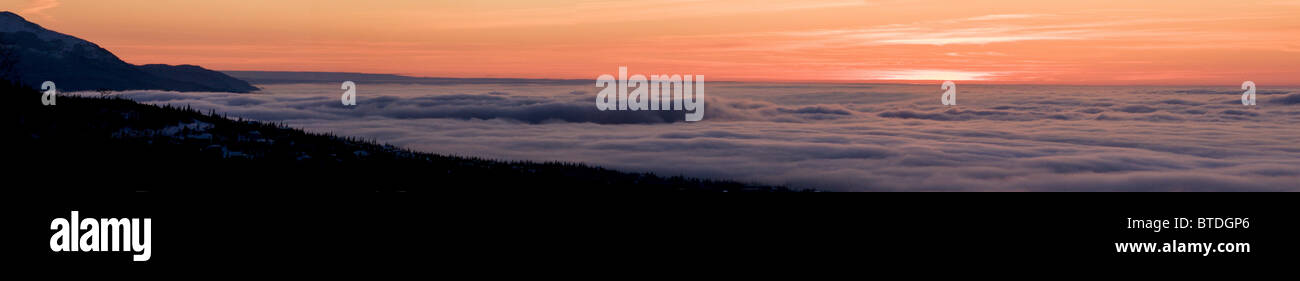 Panoramic view of a fog-enshrouded Cook Inlet near Anchorage at sunset ...