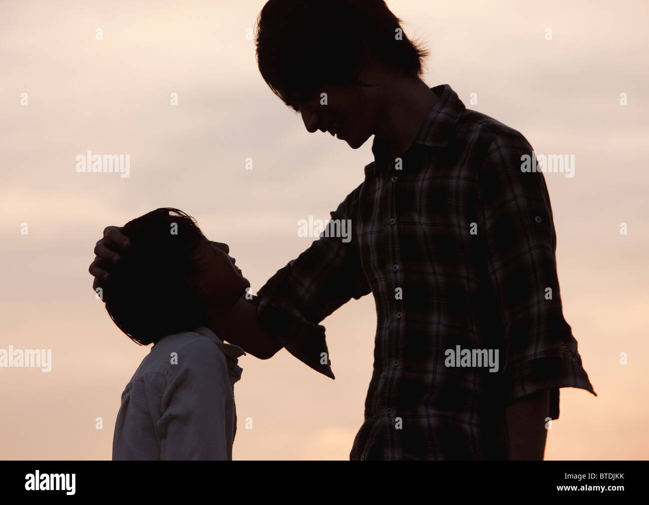 Father stroking sons head Stock Photo - Alamy