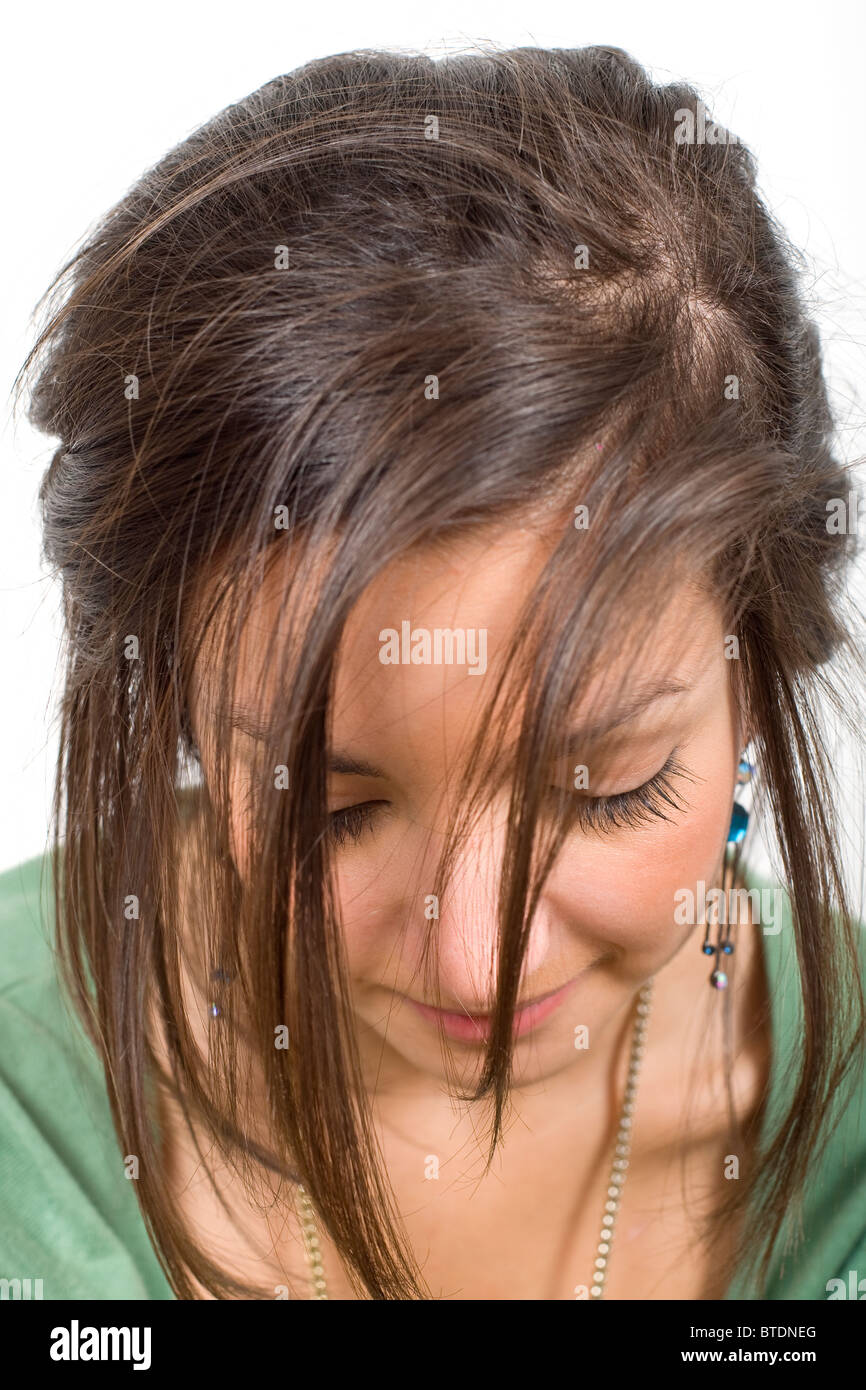 Indoor Portrait of Teenage Girl Looking Down with Hair Falling over ...