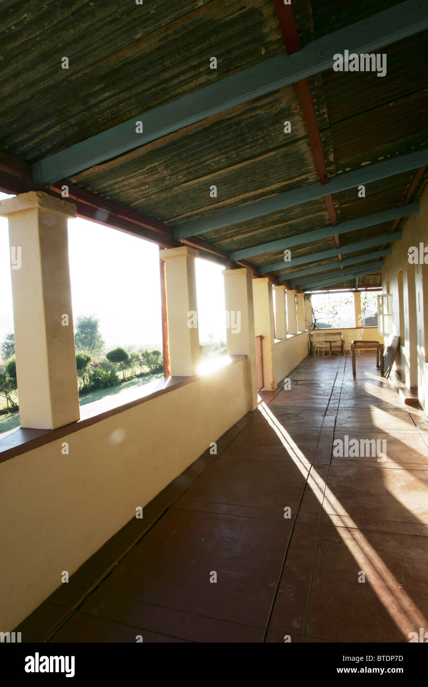 The veranda of an old farm house with sunlight streaming on to the ...