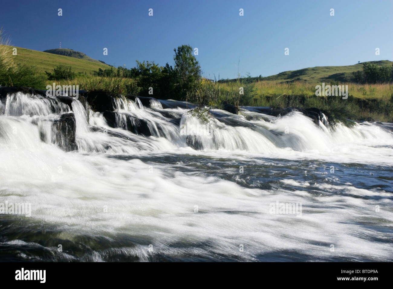 A river flowing swiftly over rocks Stock Photo - Alamy