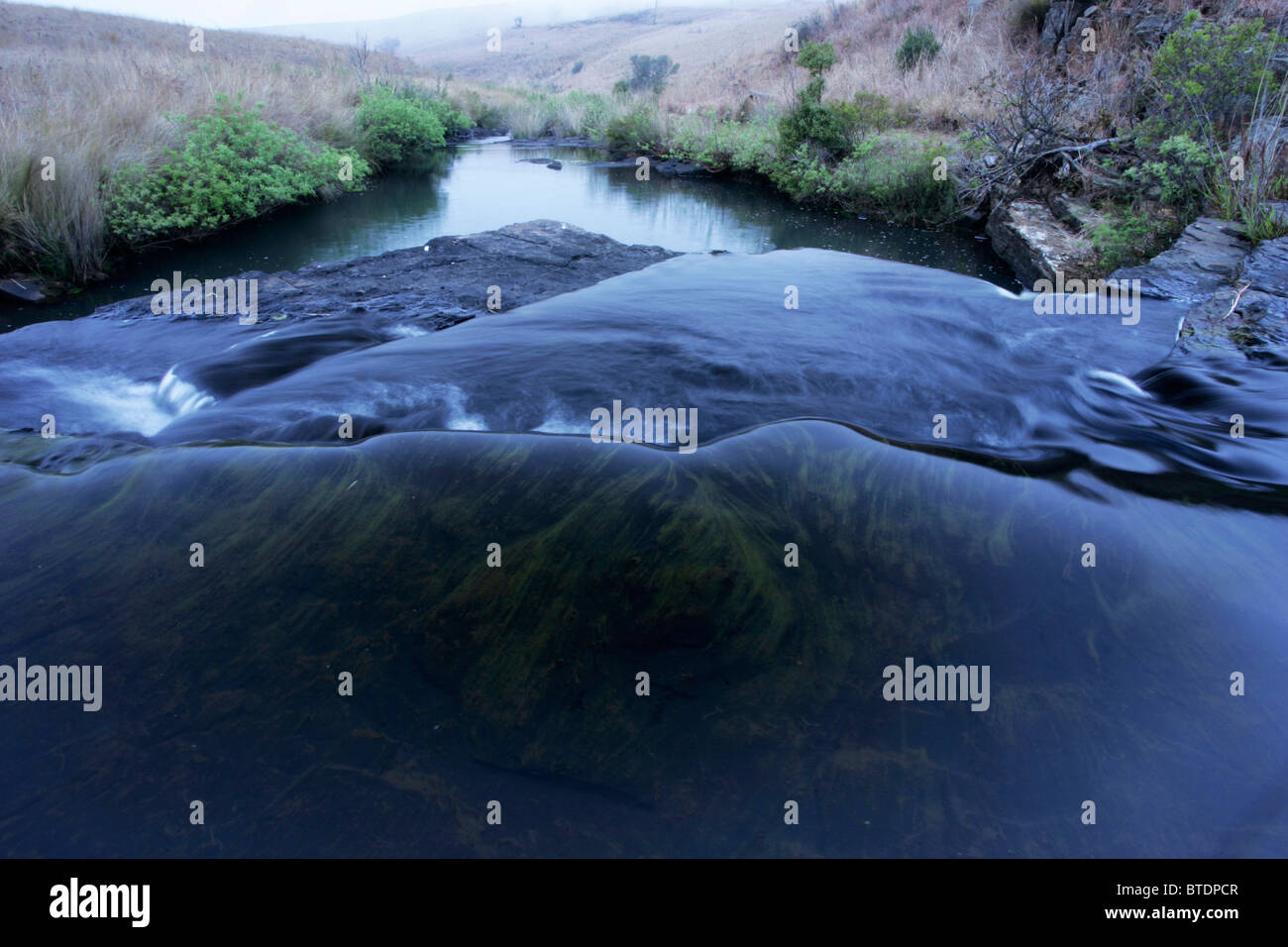 Stream flowing into rocks hi-res stock photography and images - Alamy
