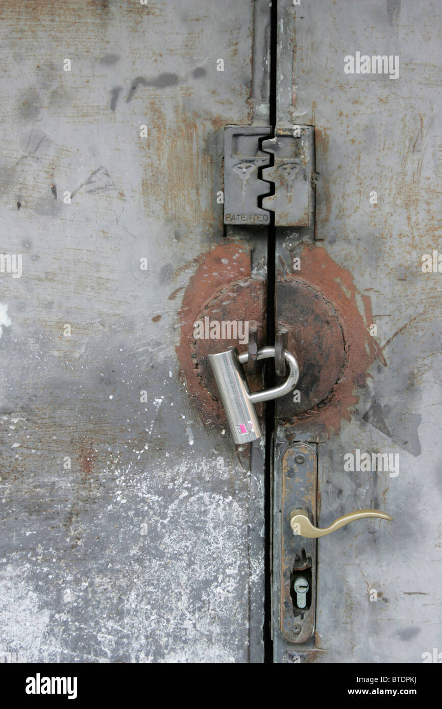 Metal door with custom lock and padlock Stock Photo - Alamy