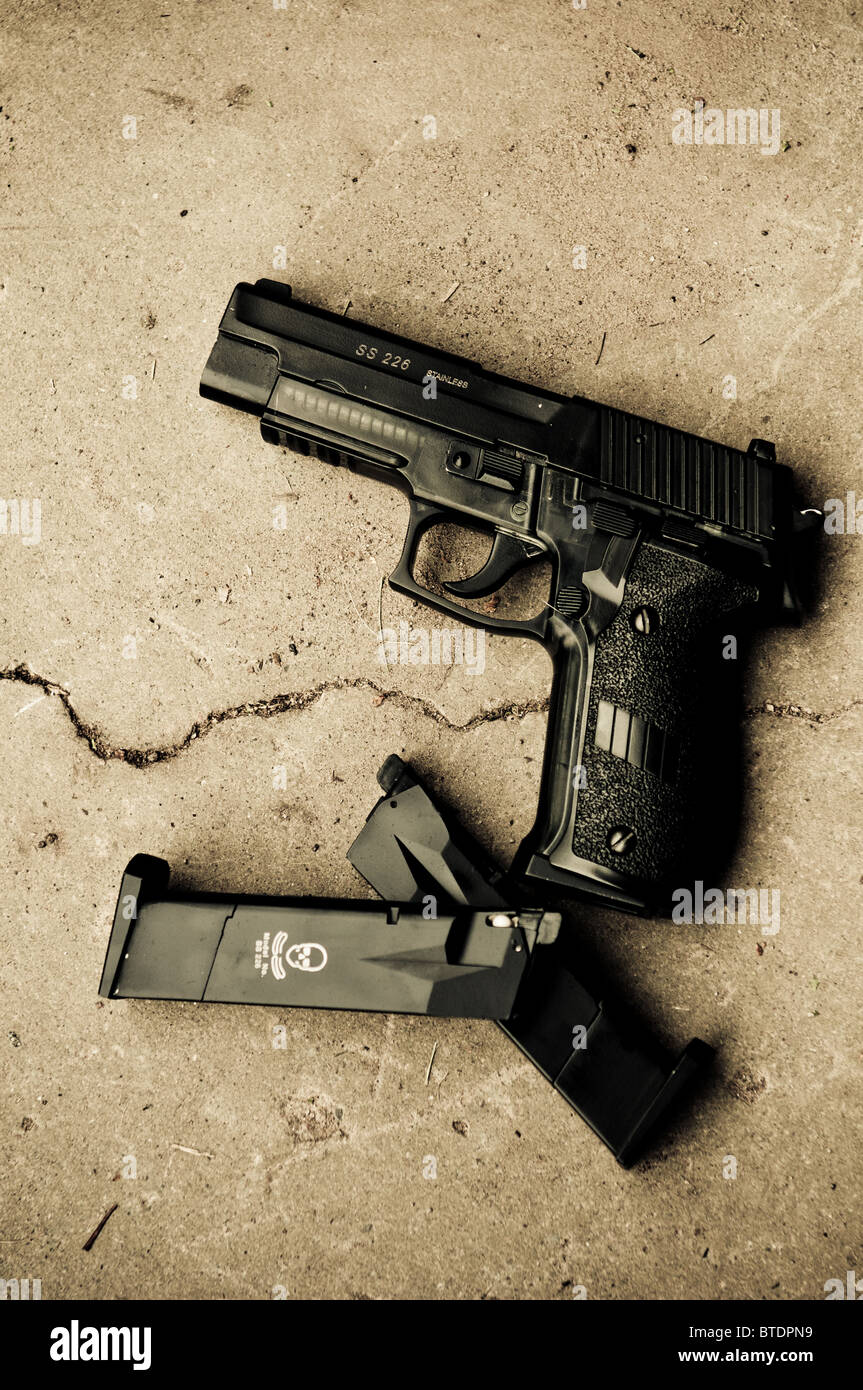 Gun and ammo clip on the ground Stock Photo - Alamy