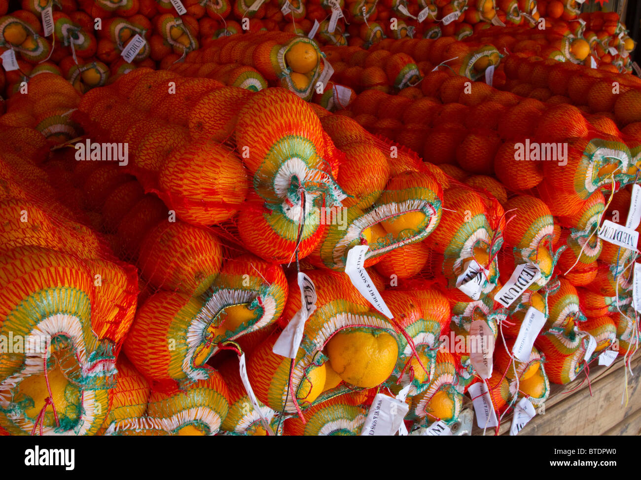 Oranges packed in bags and stored on top of each other Stock Photo - Alamy
