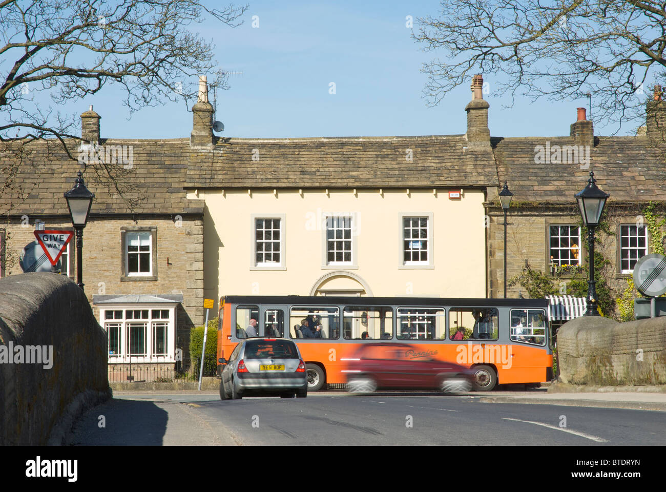 Bus stopping to pick up passengers in the village of Gargrave, North ...