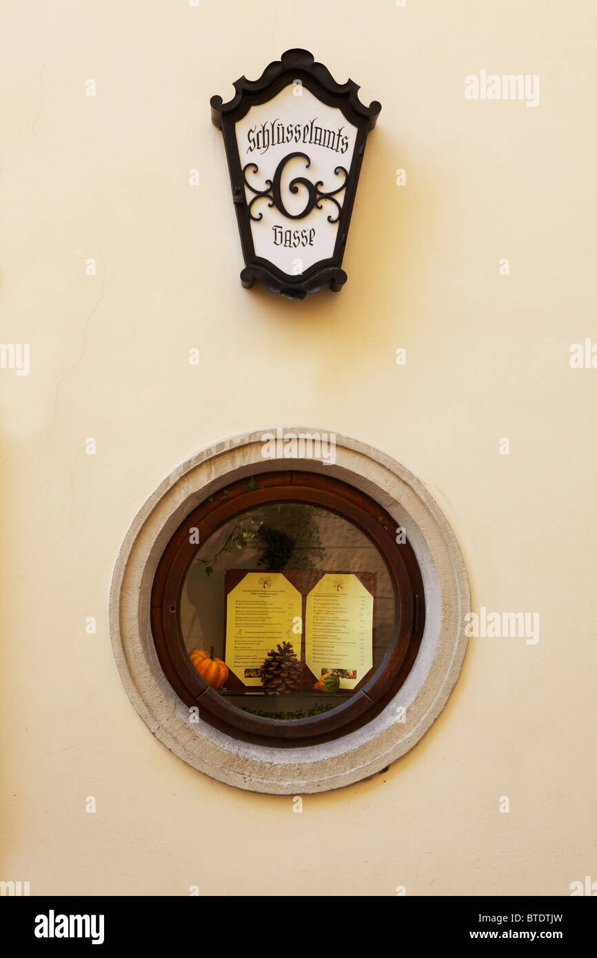 round window with restaurant menu plaque Stock Photo - Alamy