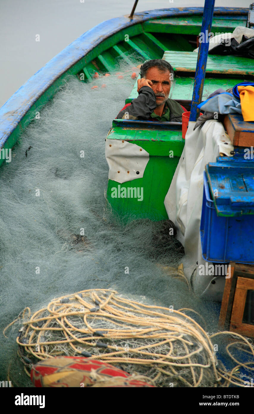 Fisherman with nets on fishing boat Stock Photo - Alamy