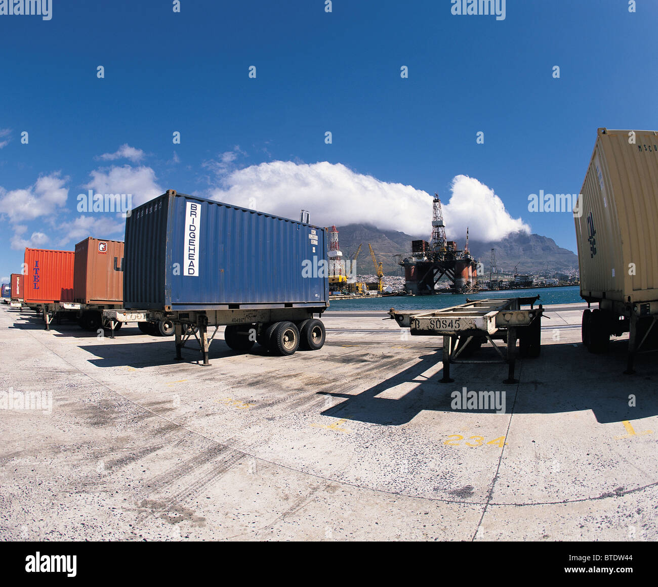 Containers waiting to be transported by trucks Stock Photo - Alamy