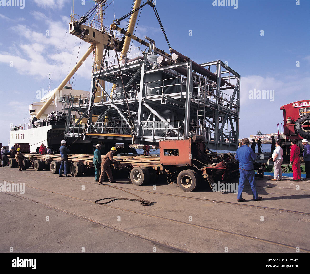 A platform being loaded from a trailer onto a ship Stock Photo - Alamy