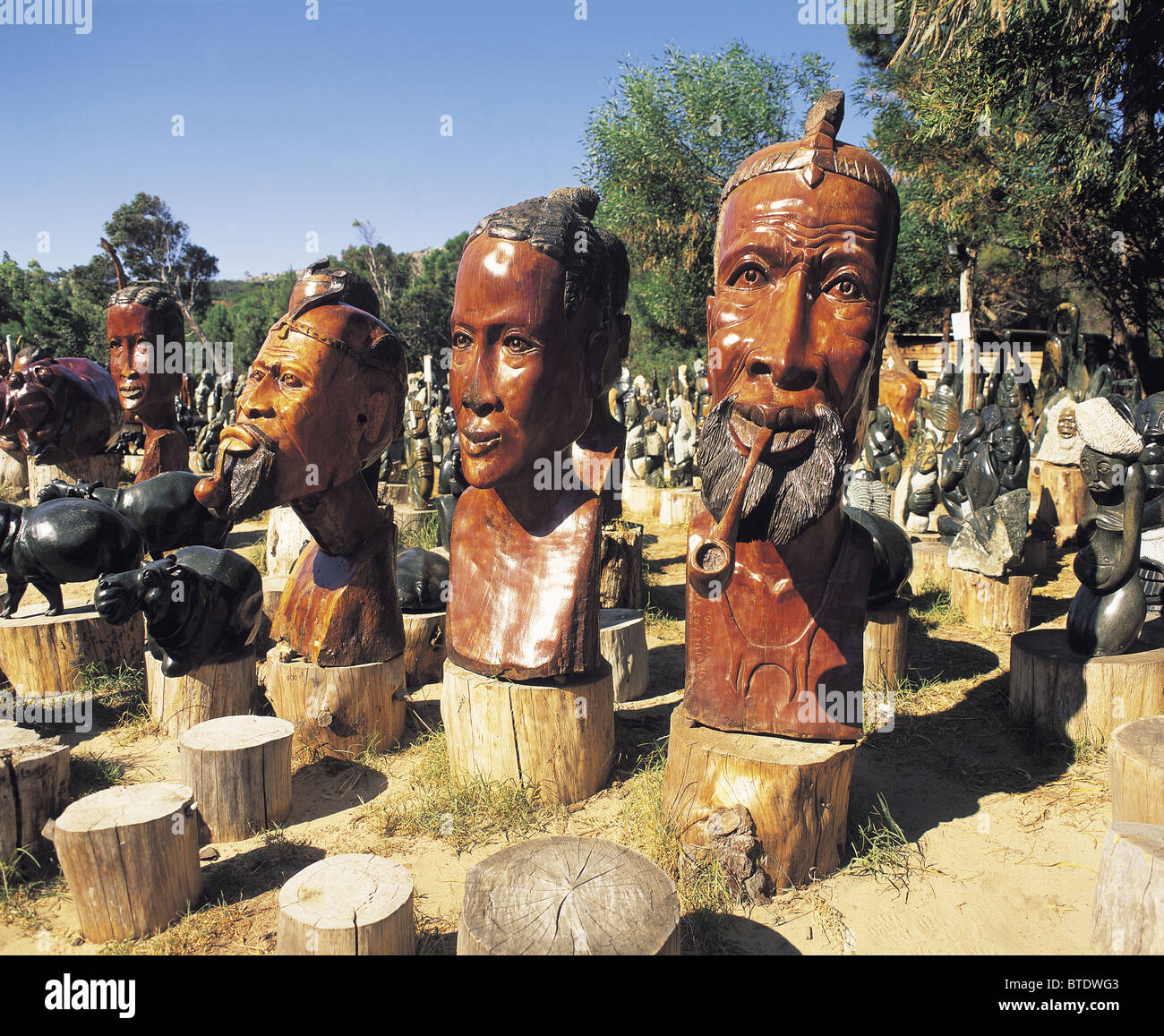 Large human faces carved out of wood Stock Photo - Alamy