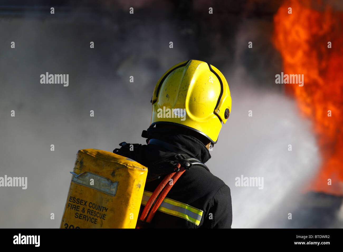 Water being sprayed onto fire Stock Photo - Alamy
