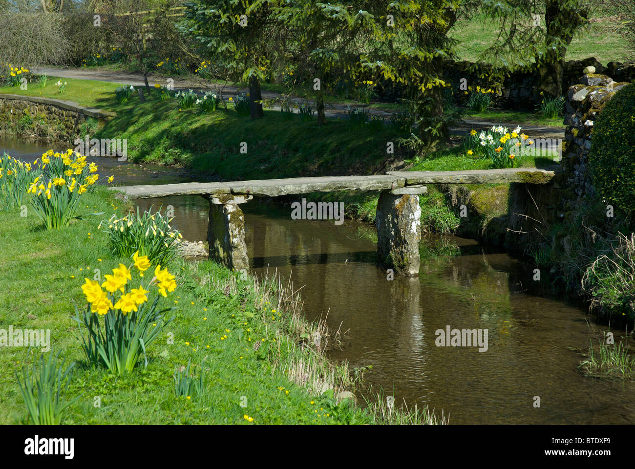 Small clapper bridge over stream, at Bank Newton, North Yorkshire ...