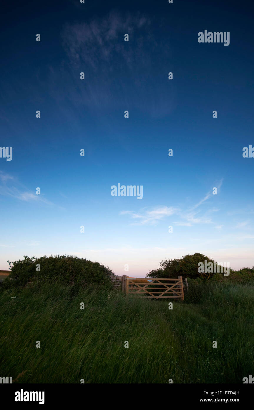 Farm gate and blue evening sky Stock Photo - Alamy
