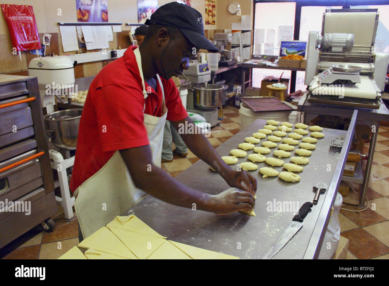 Baker at work in the In Food Bakery Stock Photo - Alamy