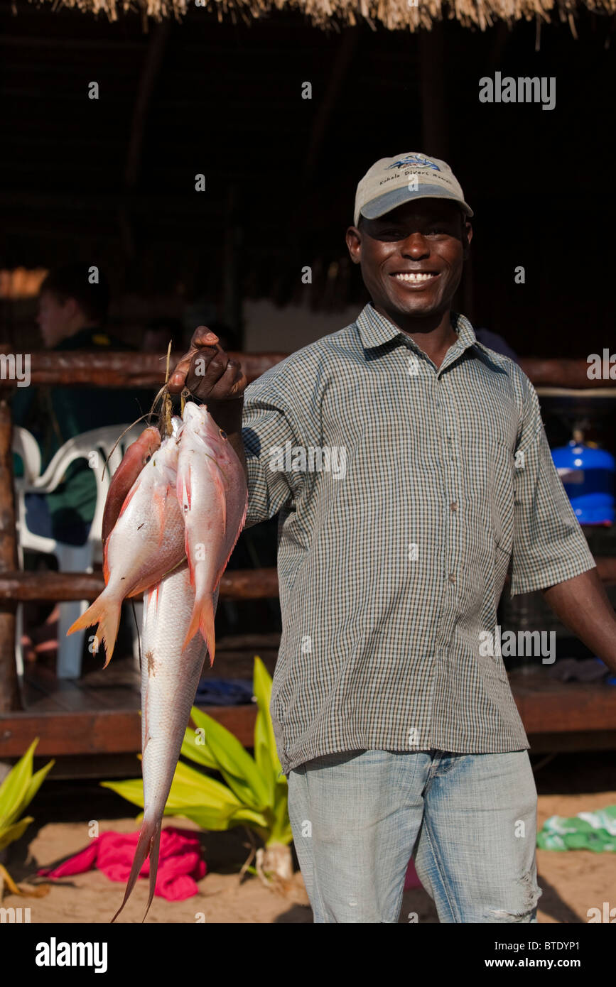 Local fisherman holding freshly caught fish for sale Stock Photo - Alamy