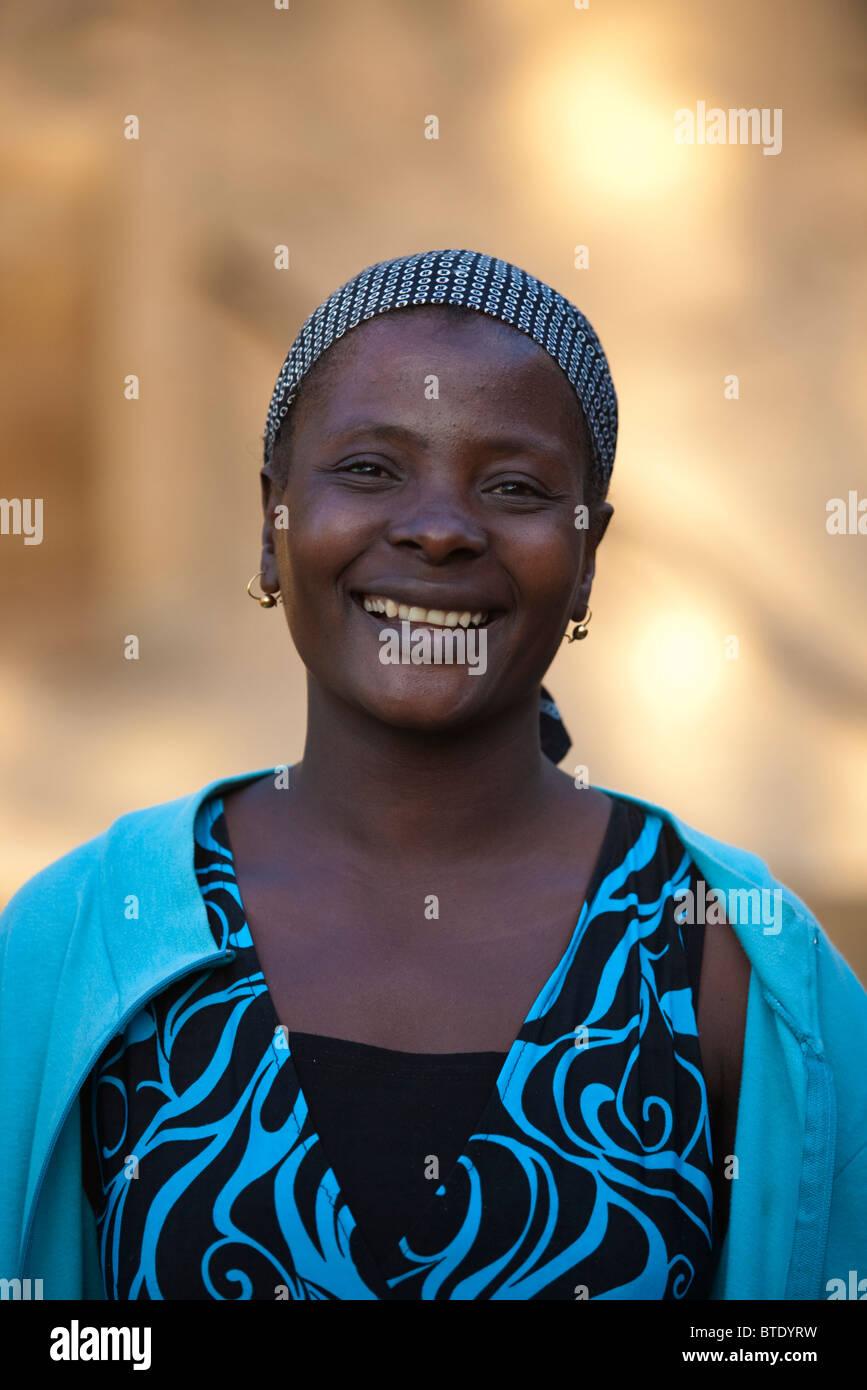 Portrait of a smiling local woman dressed in turquoise Stock Photo - Alamy