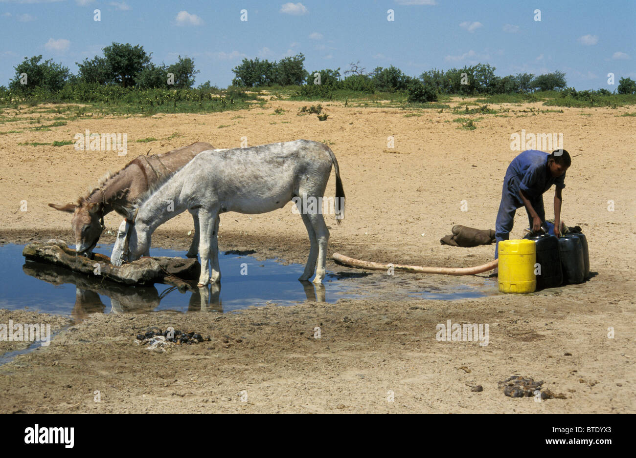 Boy fetching water at borehole in rural Botswana Stock Photo - Alamy