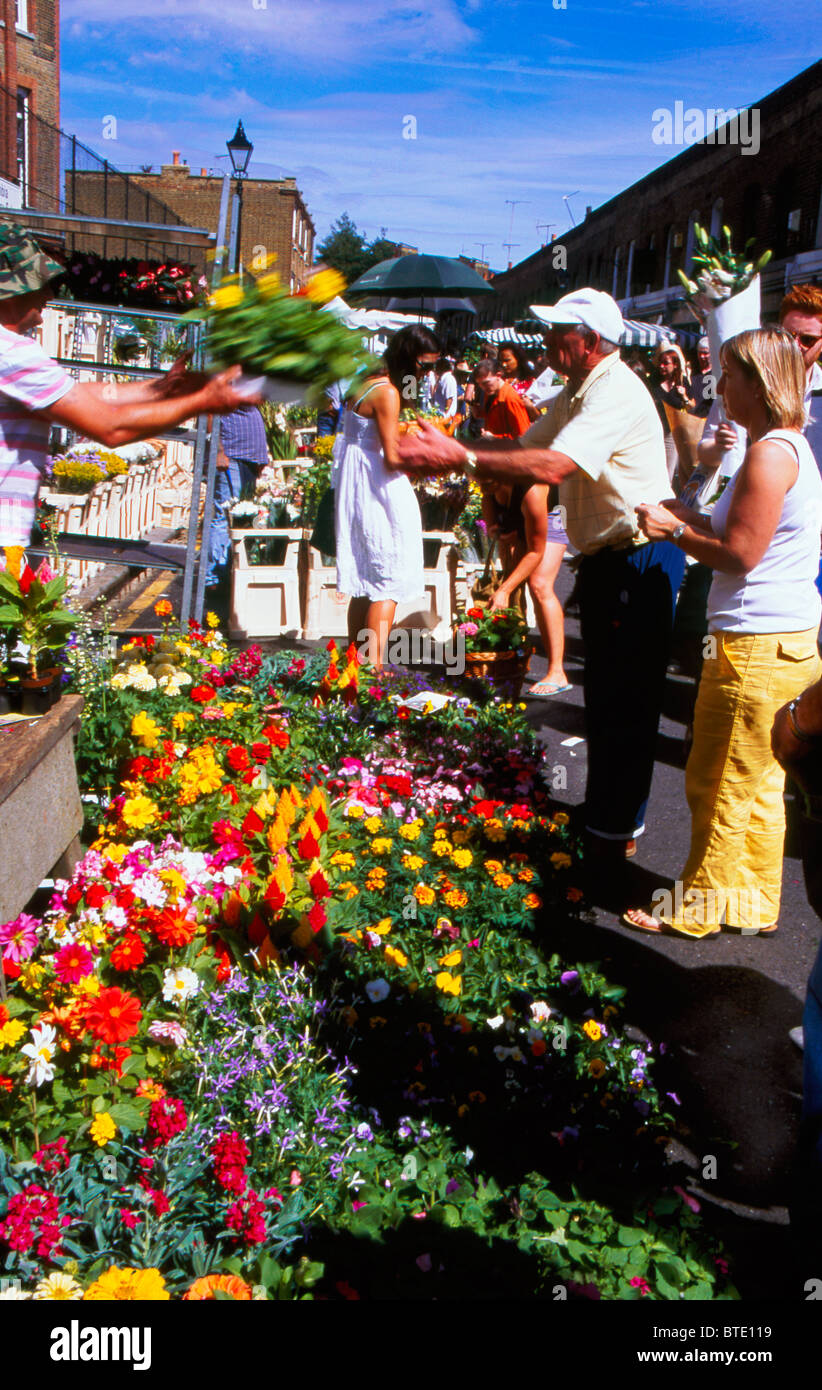 Columbia Road Sunday flower market with street traders throwing plants ...