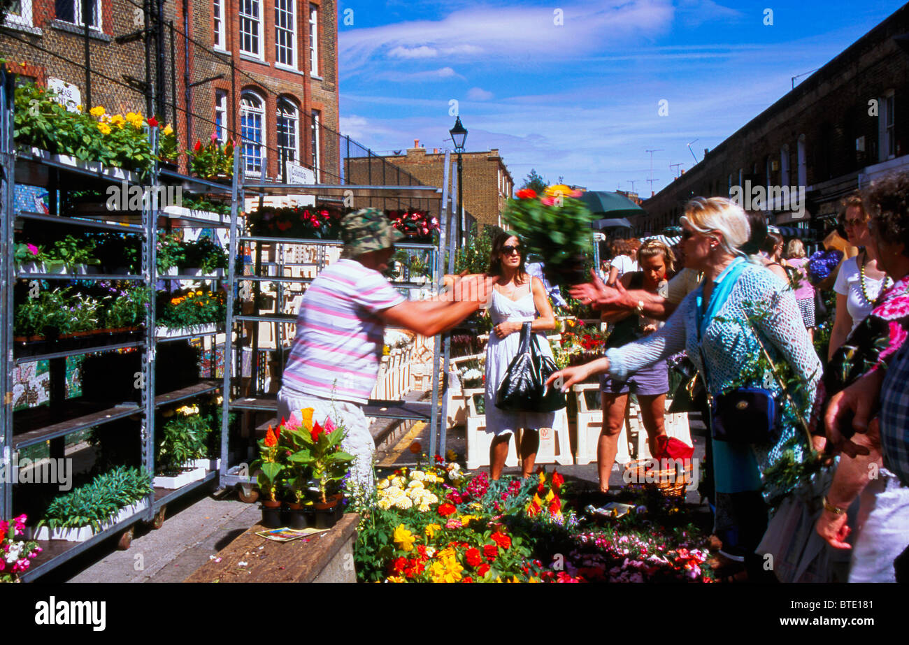 Columbia Road Sunday flower market with street traders throwing plants ...